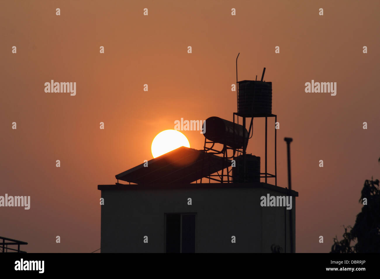 Sunset behind Solar water heater Stock Photo - Alamy