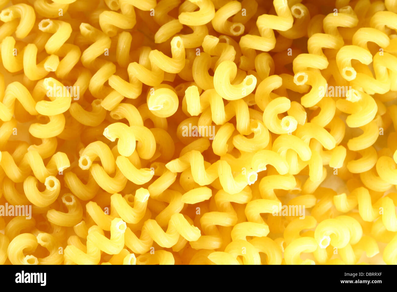 macro Macaroni yellow food background Stock Photo - Alamy