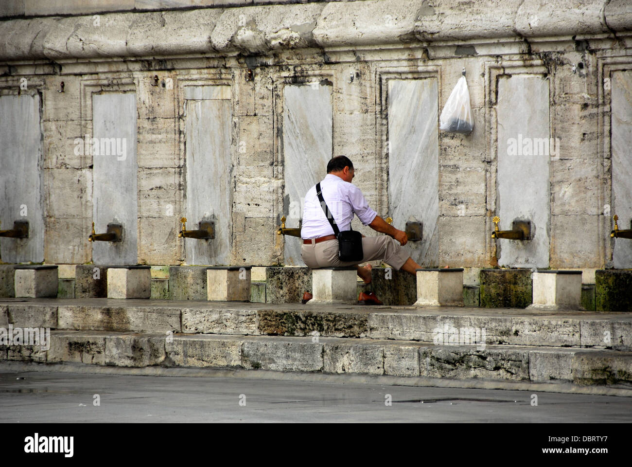 Street scene in Istanbul, Turkey. Moslem man washing feet Stock Photo ...