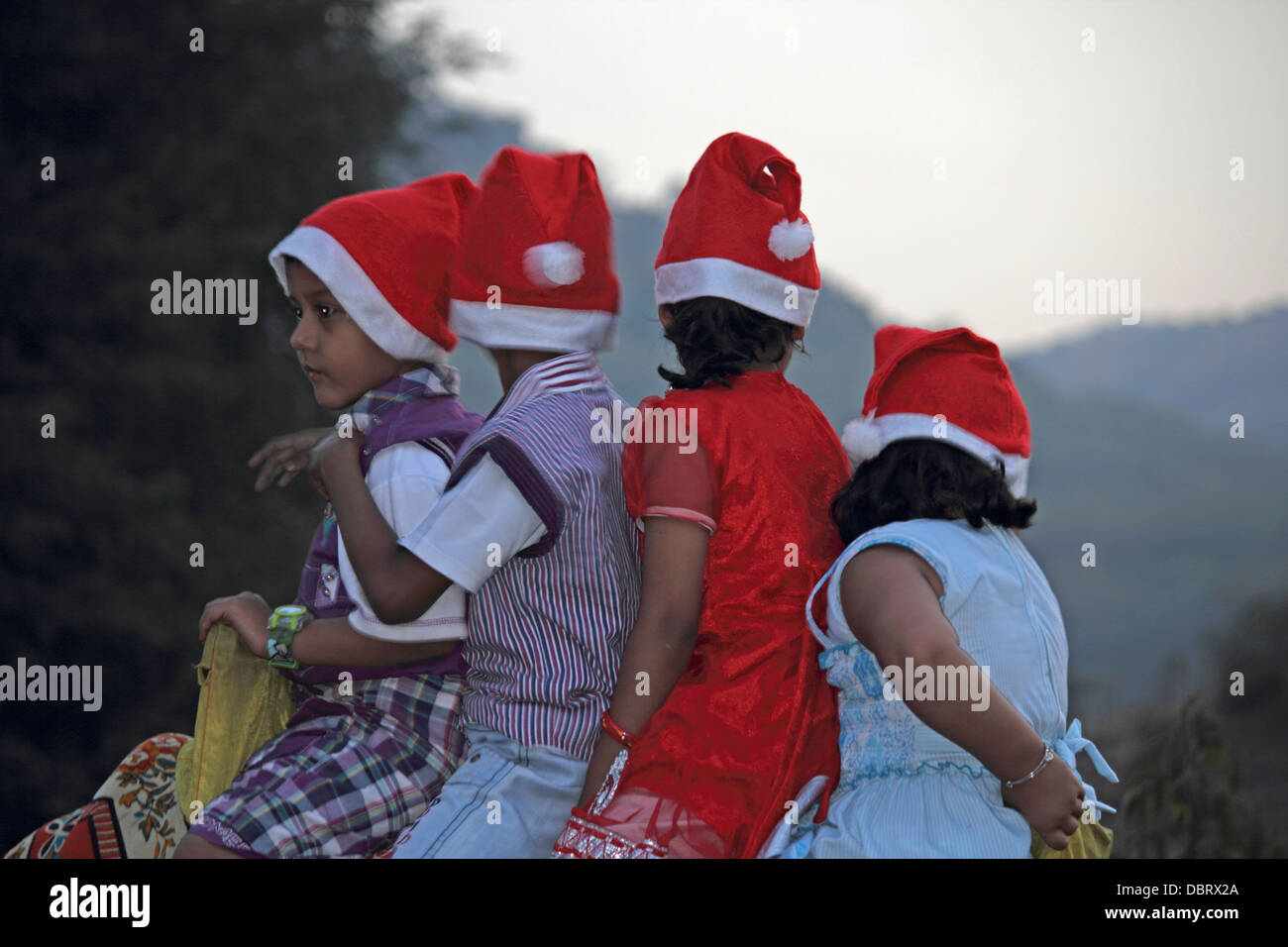 Young children sitting on camel and wearing Santa Claus caps Stock ...