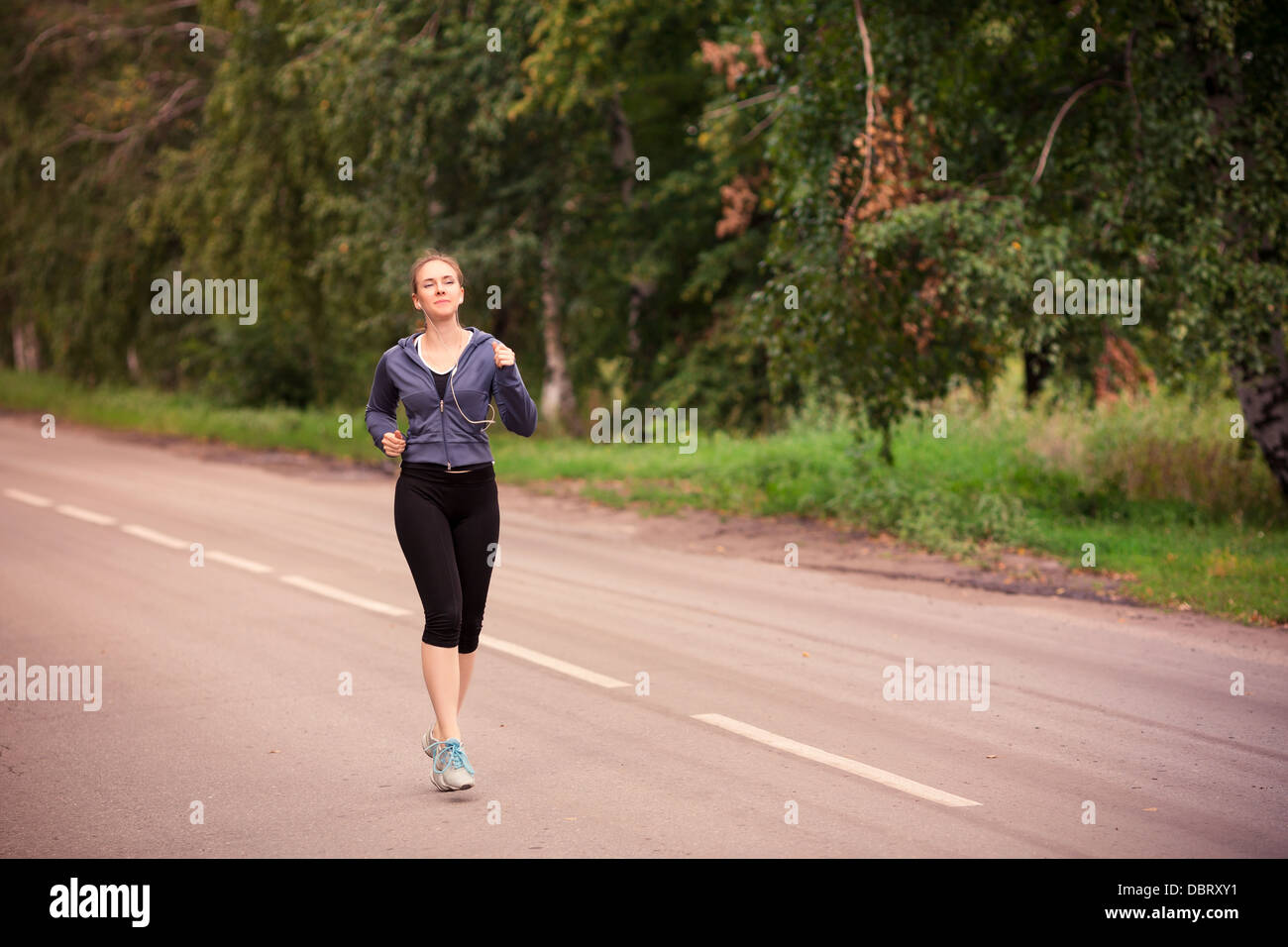 Beautiful fit runner woman jogging in nature outdoor Stock Photo - Alamy