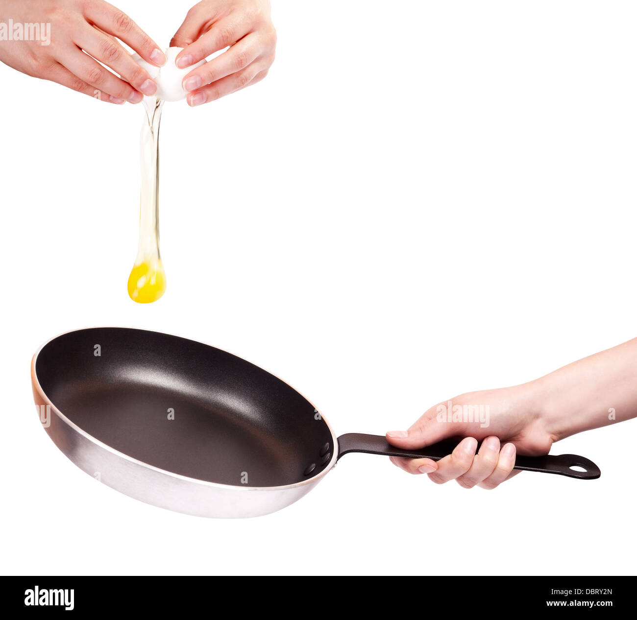 Yolk dropping in pan from cracked raw egg, divided by woman hands Stock ...