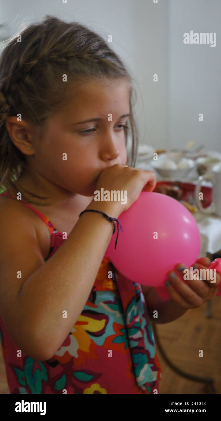 girl blowing balloon Stock Photo - Alamy