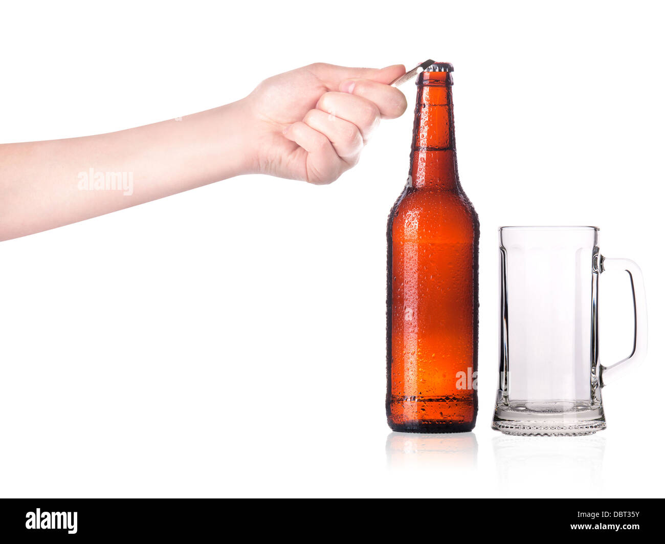 hand holding and opening beer bottle with metal opener Stock Photo - Alamy