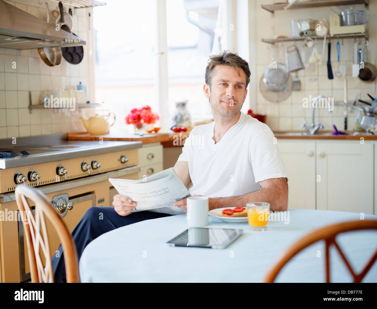 Portrait smiling man sitting breakfast table newspaper hi-res stock ...