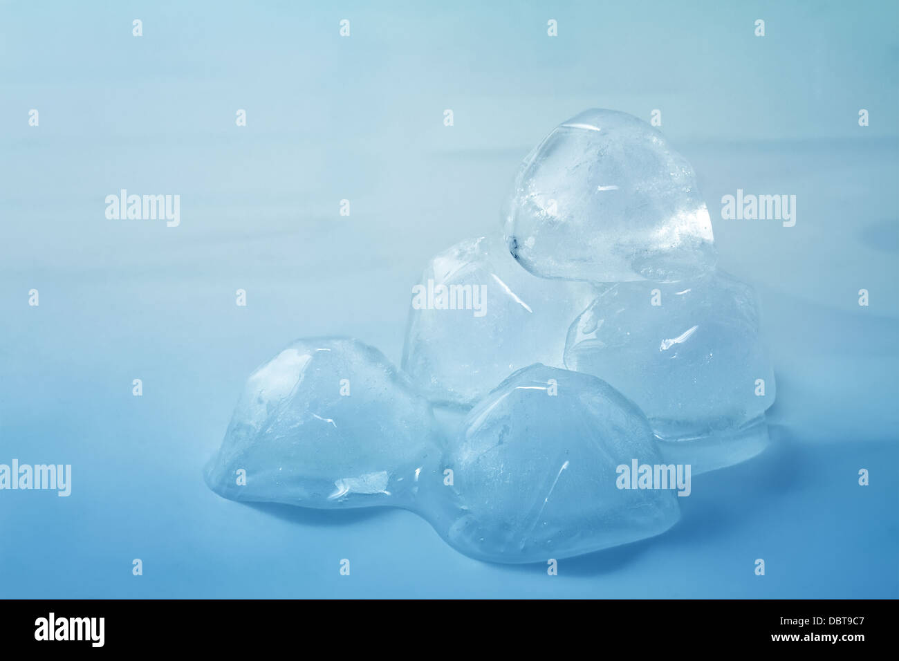 Ice cubes on blue background Stock Photo - Alamy