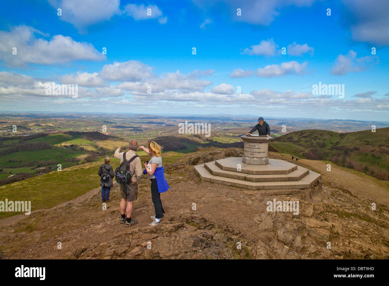 Woman using the toposcope viewer on the summit of Worcestershire Beacon ...