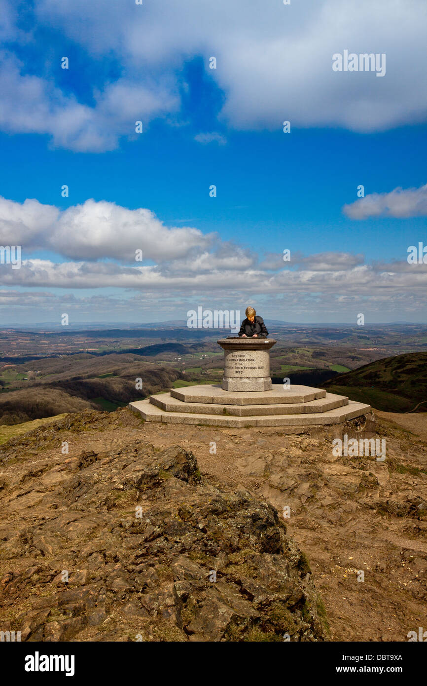 Woman using the toposcope viewer on the summit of Worcestershire Beacon ...