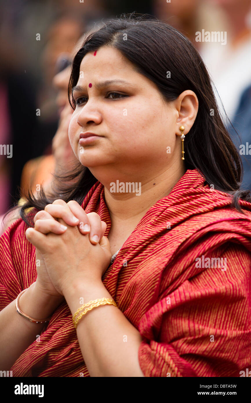 Leicester, UK, 4th August 2013. A Hare Krishna follower watches the ...