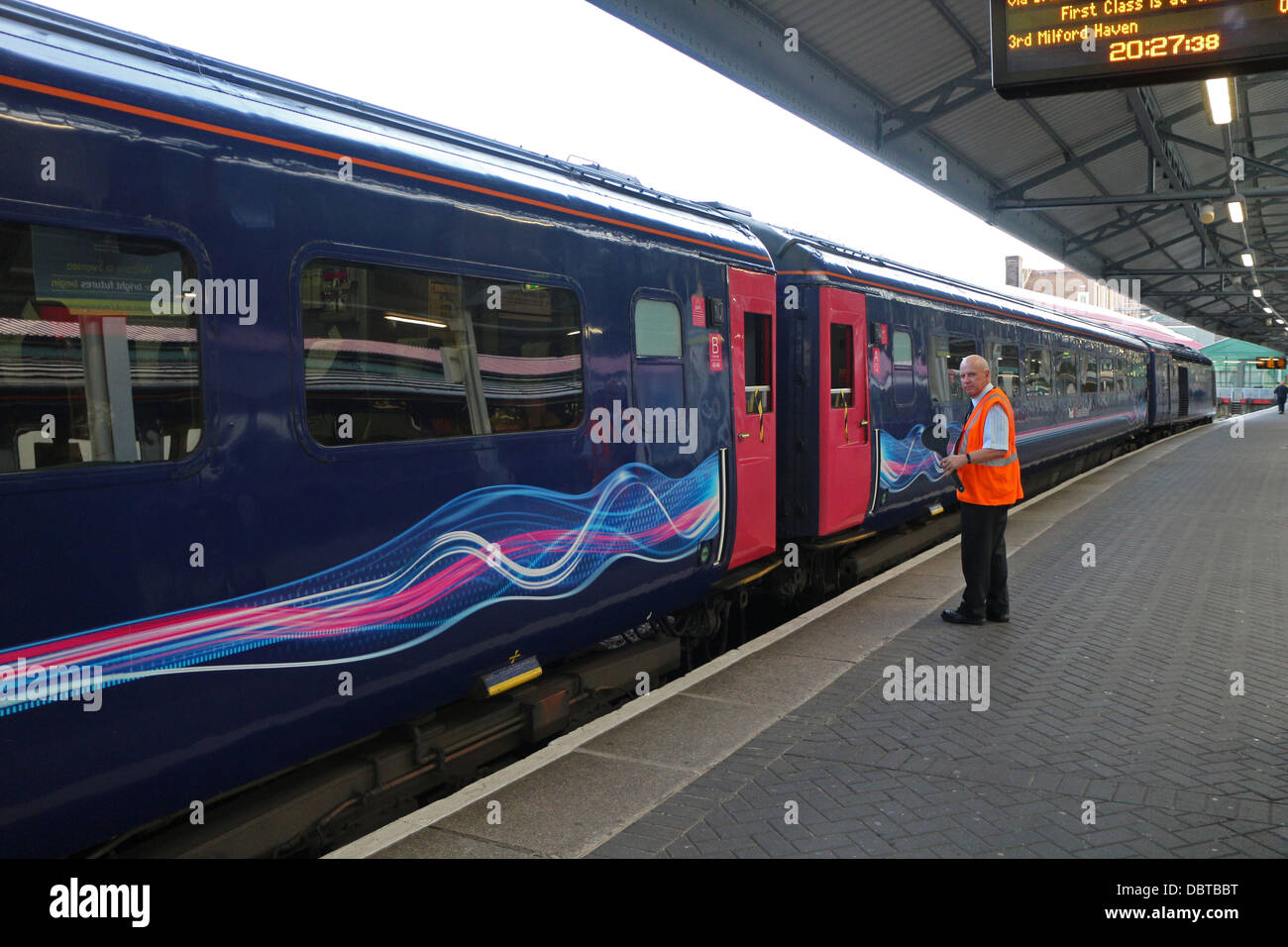 Station manager signaling train departure on Platform at Swansea ...