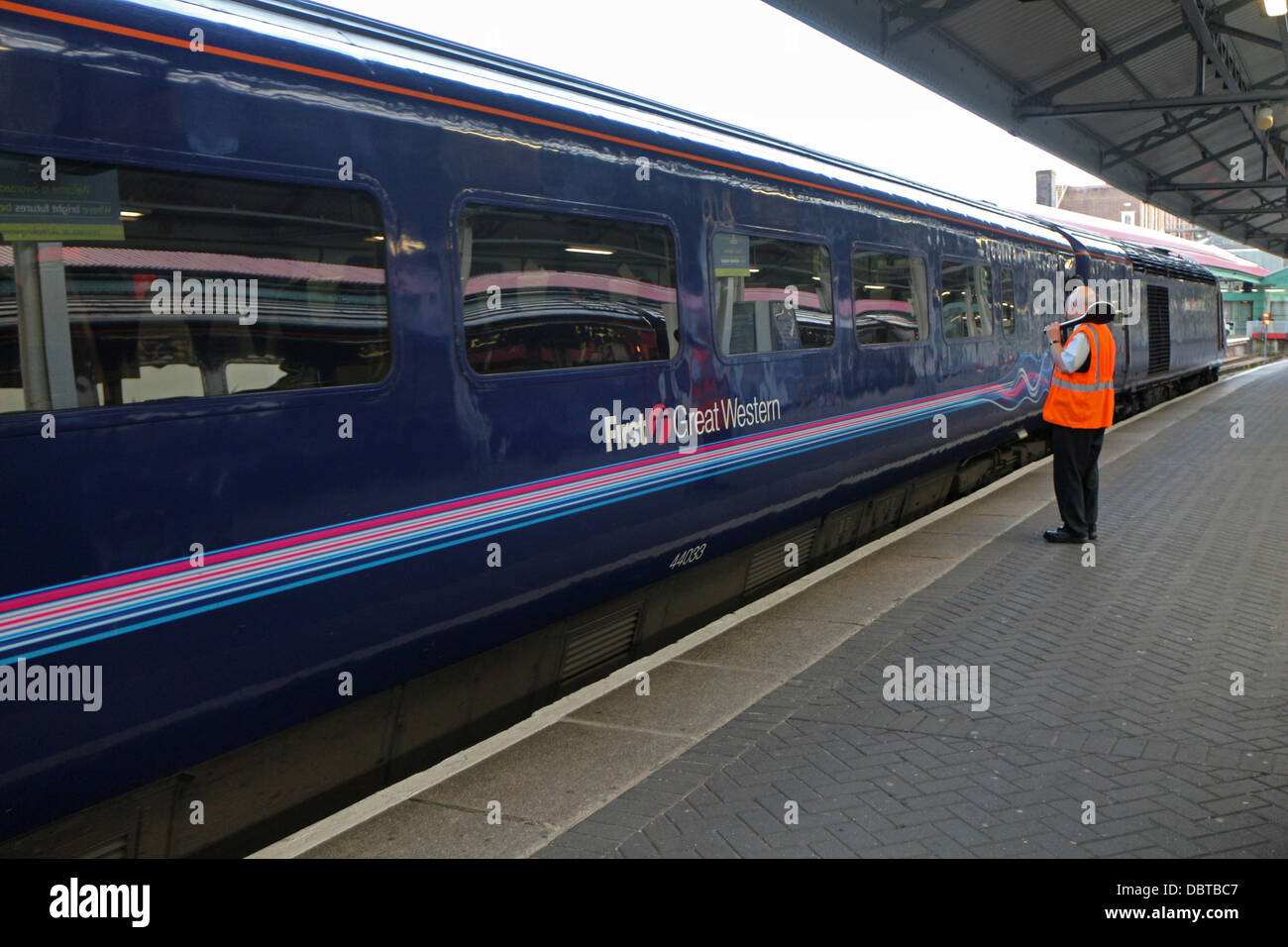 Station manager signaling train departure on Platform at Swansea ...