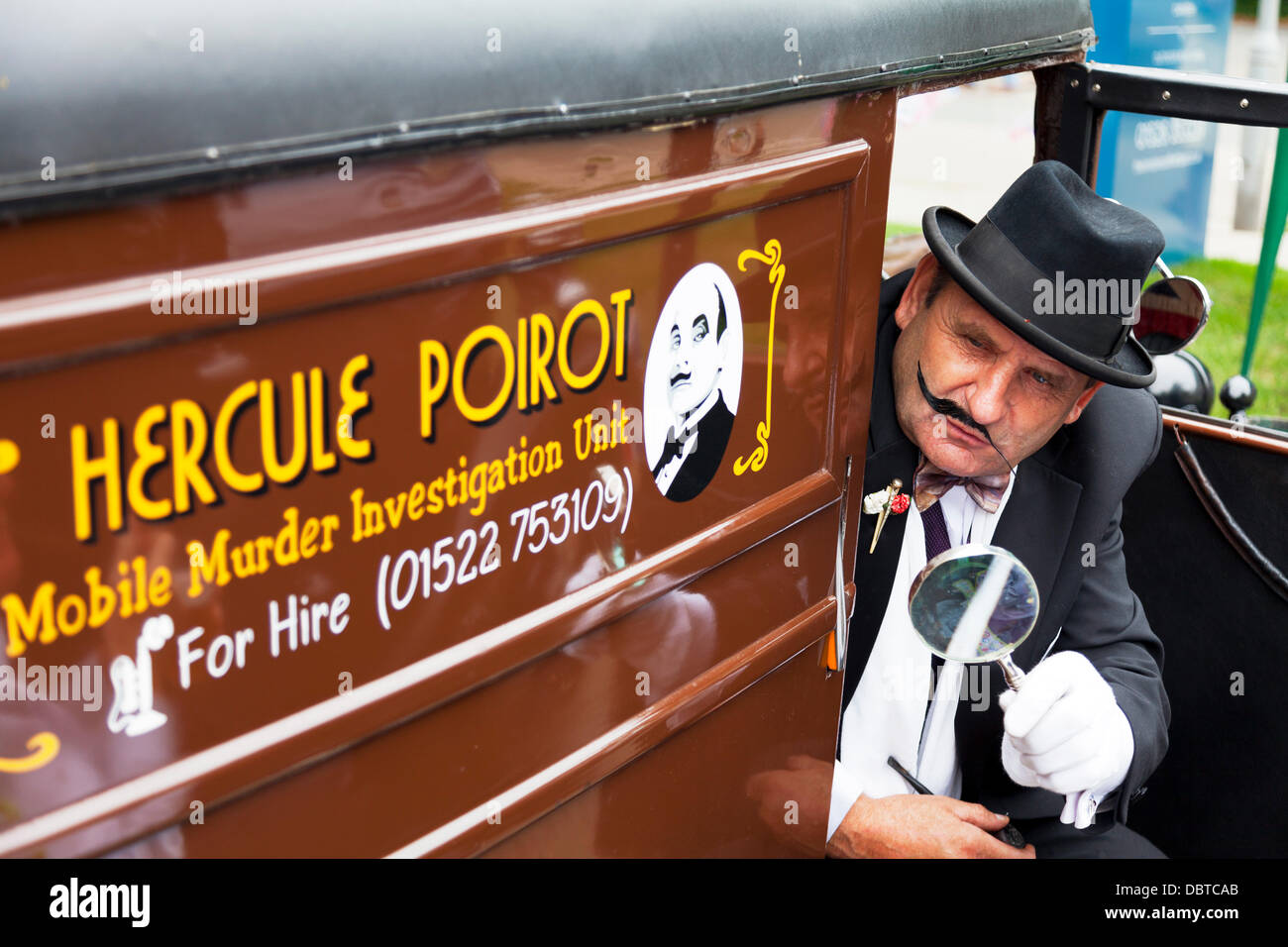 Man dressed in traditional 1940's outfit of Hercule Poirot investigator ...