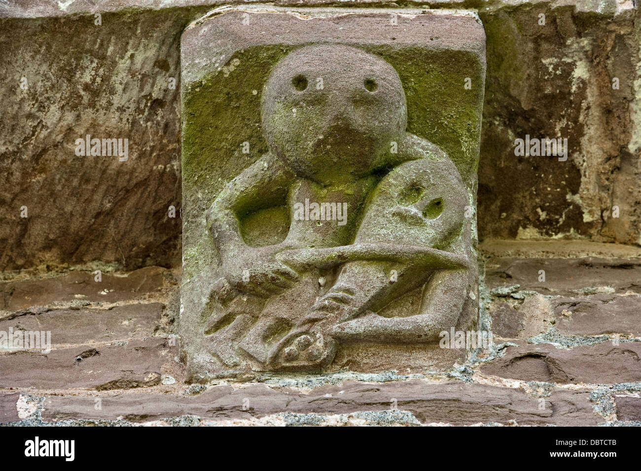A carved stone corbel showing a musician playing a fiddle, on the ...