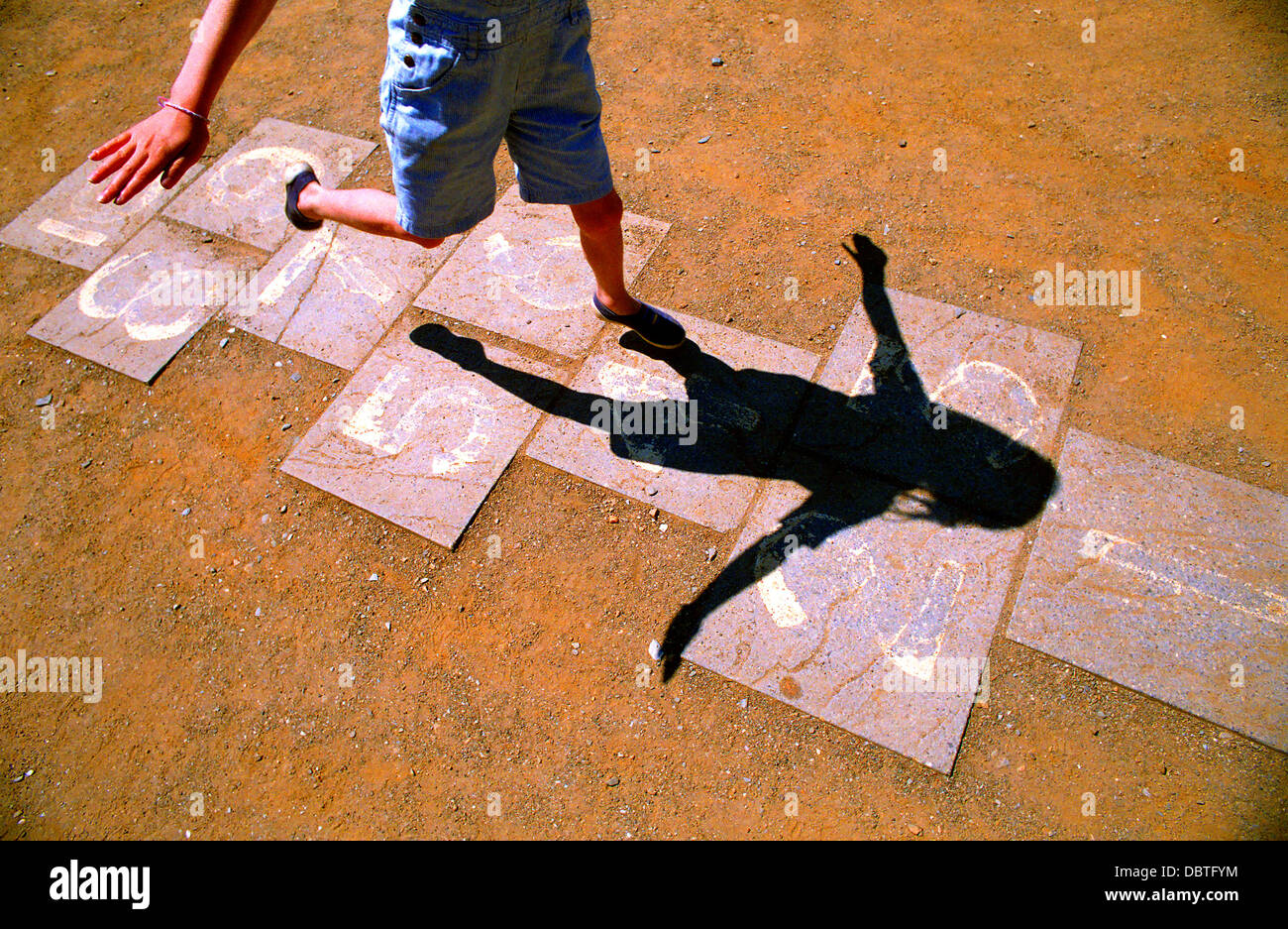 Young girl playing hopscotch. Cornwall, UK Stock Photo - Alamy