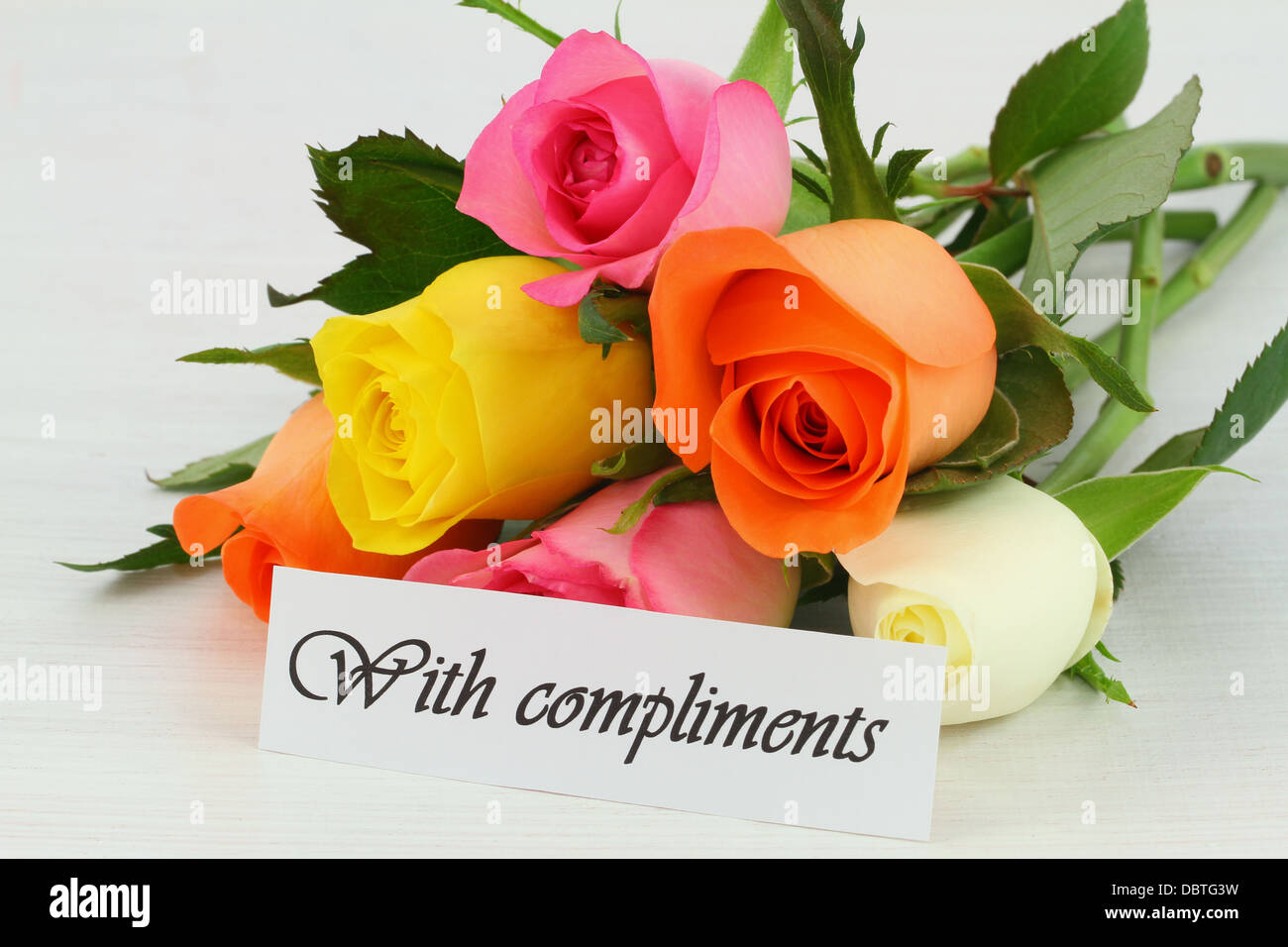 With compliments note and bouquet of colorful roses Stock Photo - Alamy