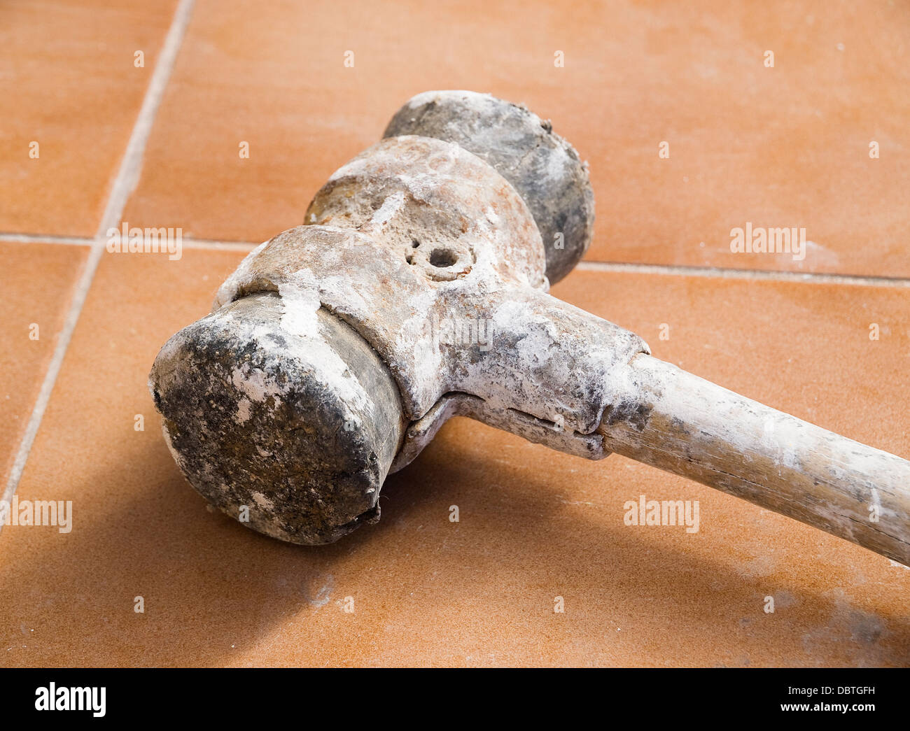 Dirty hammer on tile background in diagonal composition Stock Photo - Alamy
