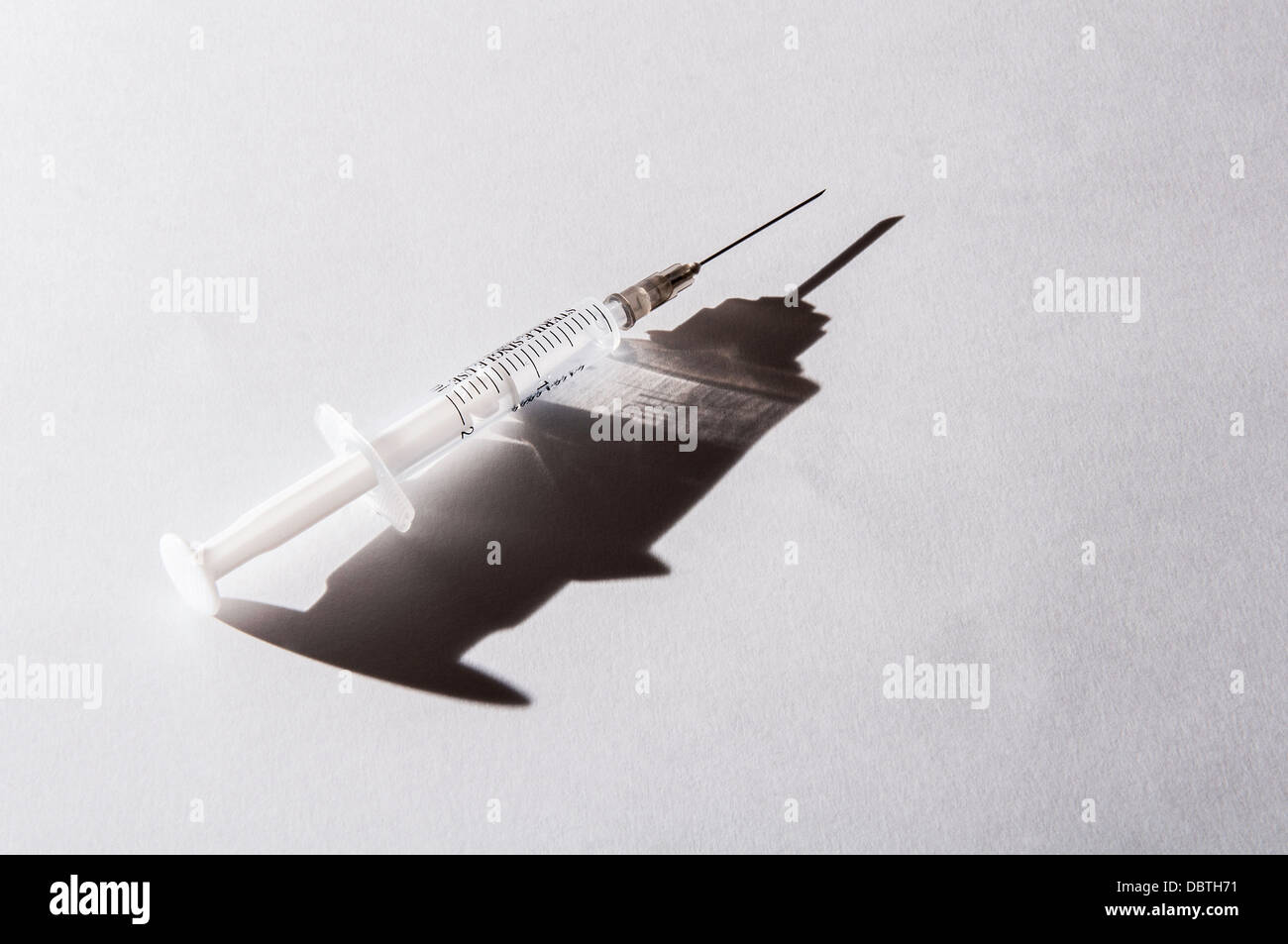 Syringe and its shadow Stock Photo - Alamy