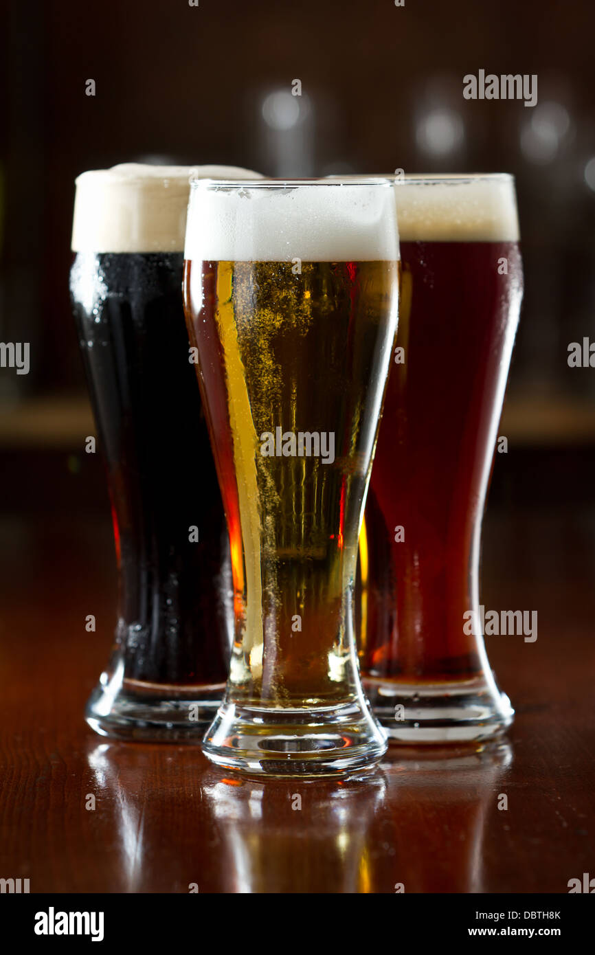 dark, red and light beer served on a dark bar Stock Photo - Alamy