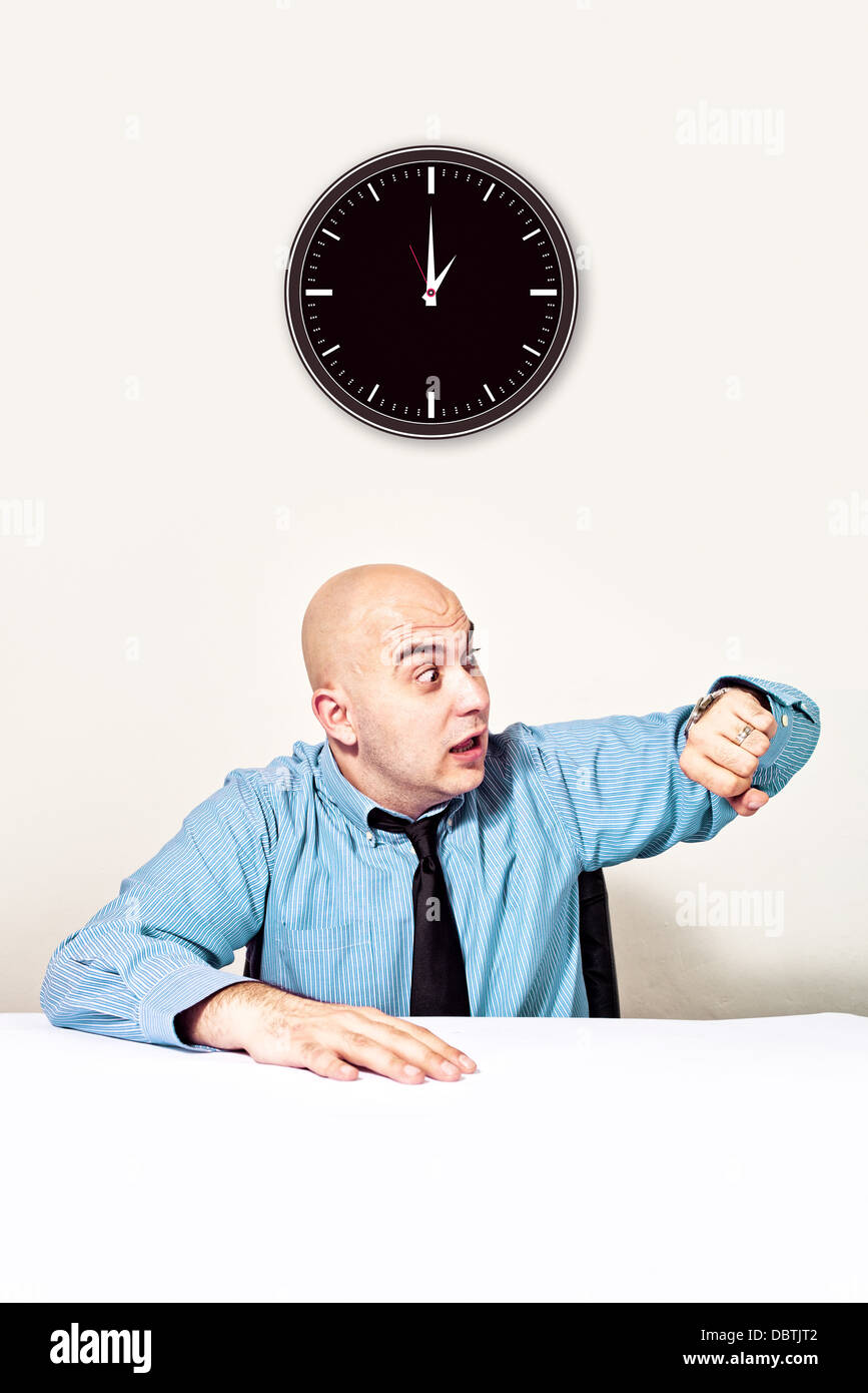 Businessman is late for a meeting.Checking time on wrist watch Stock ...