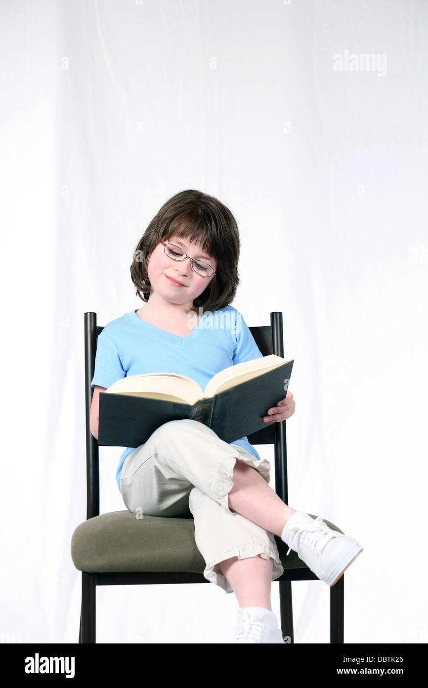 cute girl with short dark hair reading a book Stock Photo - Alamy
