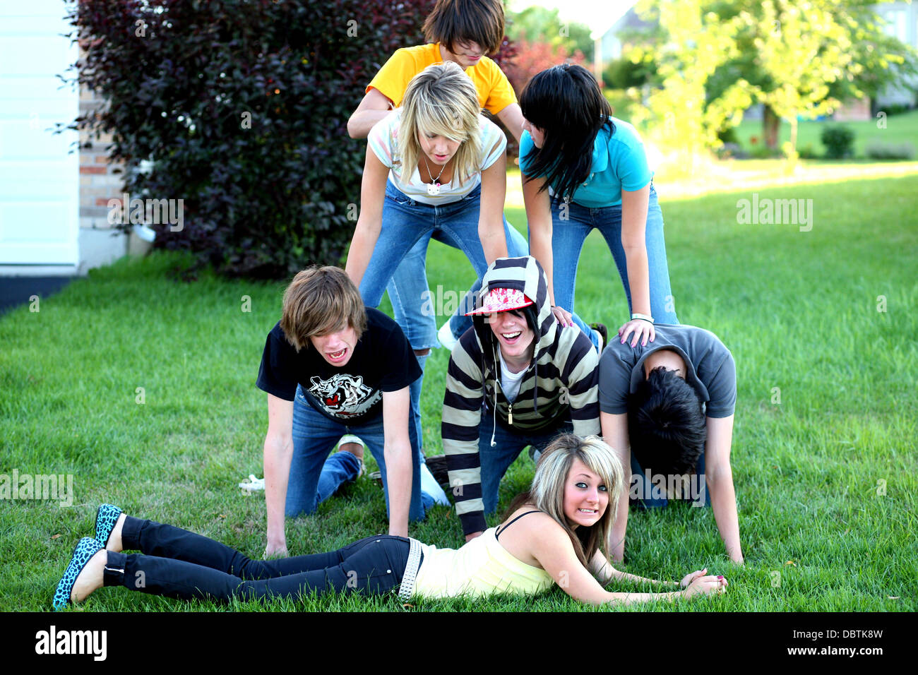 teen boys and girls making a pyramid Stock Photo - Alamy