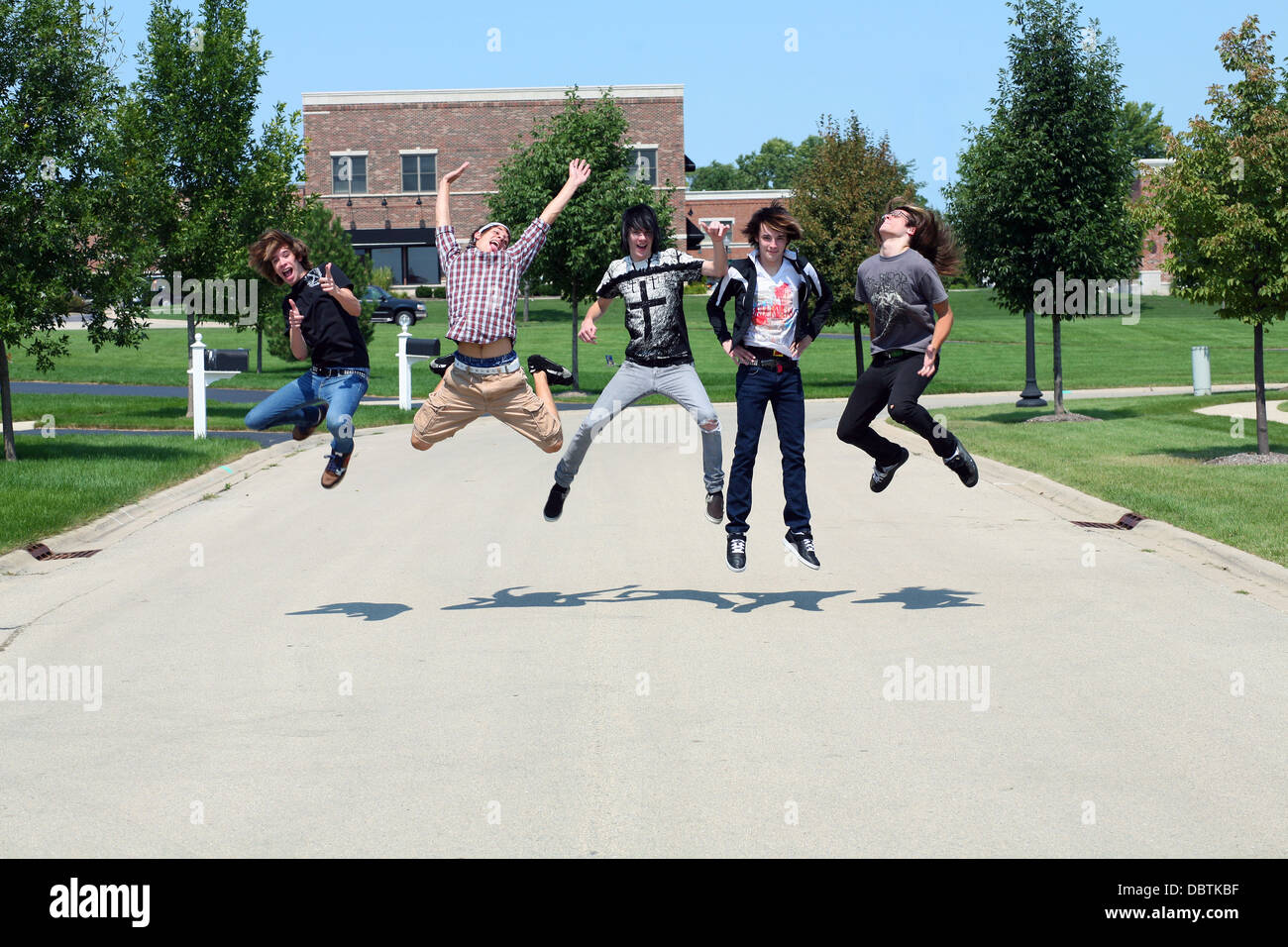 group of teen boys jumping in the street Stock Photo - Alamy