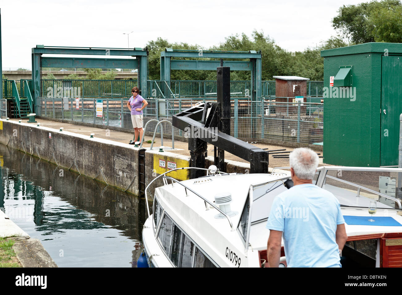 Man navigating boat through Lock on the River Nene at Orton ...