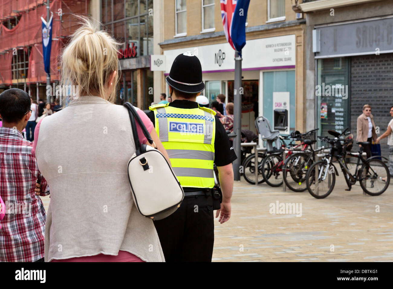 Police officer patrolling the streets of Peterborough on Armed Forces ...