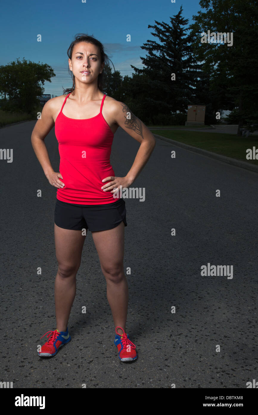 Woman runner standing on city street Stock Photo - Alamy