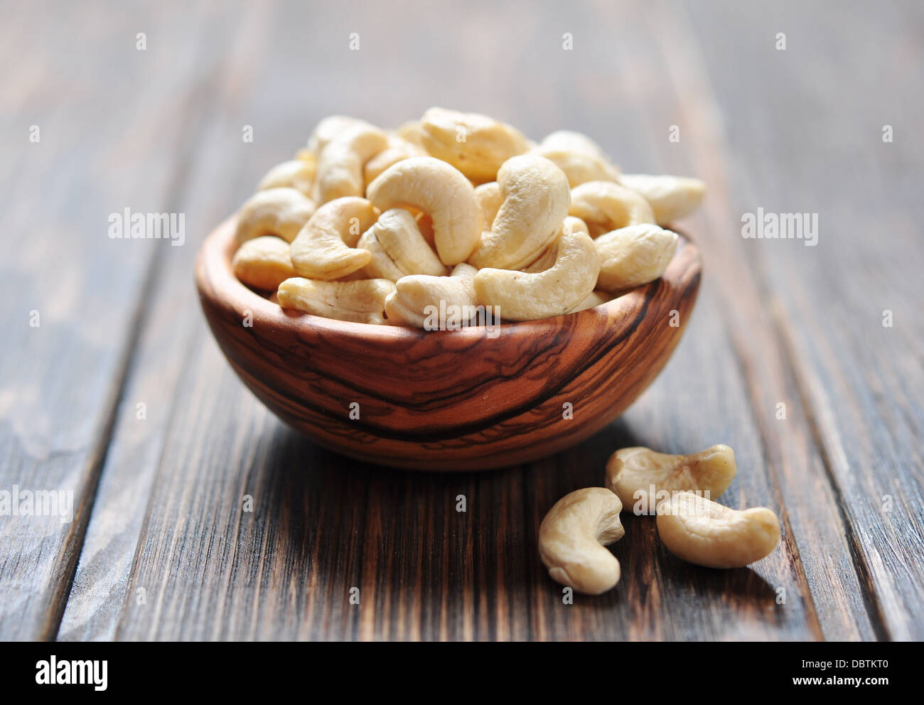 Roasted cashews on natural wooden table background Stock Photo - Alamy