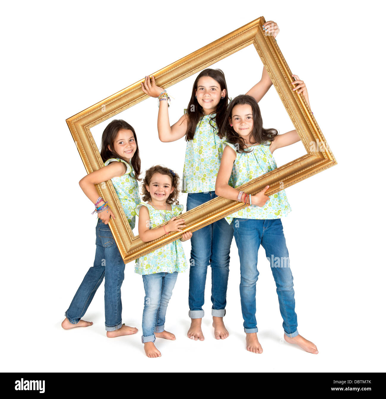Group of young girls posing with a golden frame Stock Photo - Alamy