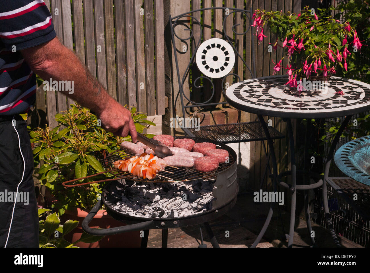 Man Cooking Food On A barbeque Stock Photo - Alamy