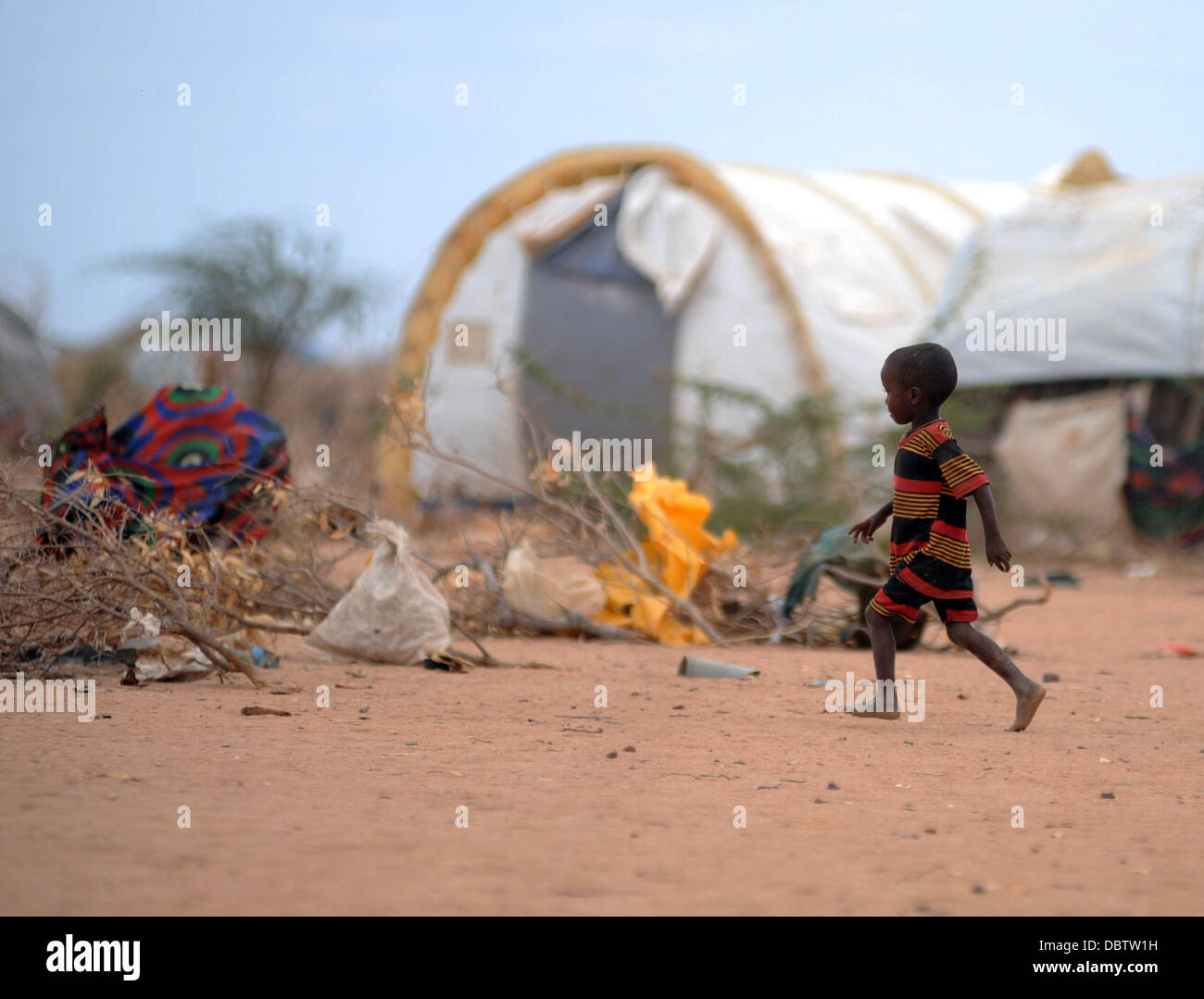 Somali residents of a camp for Internally Displace Persons stand next ...
