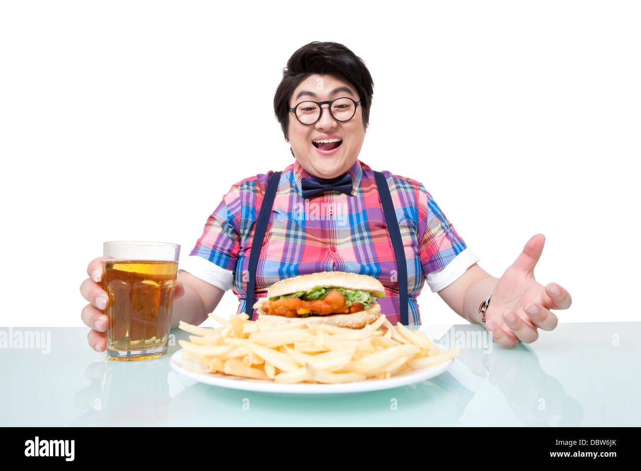 Overweight young man eating fast food Stock Photo - Alamy