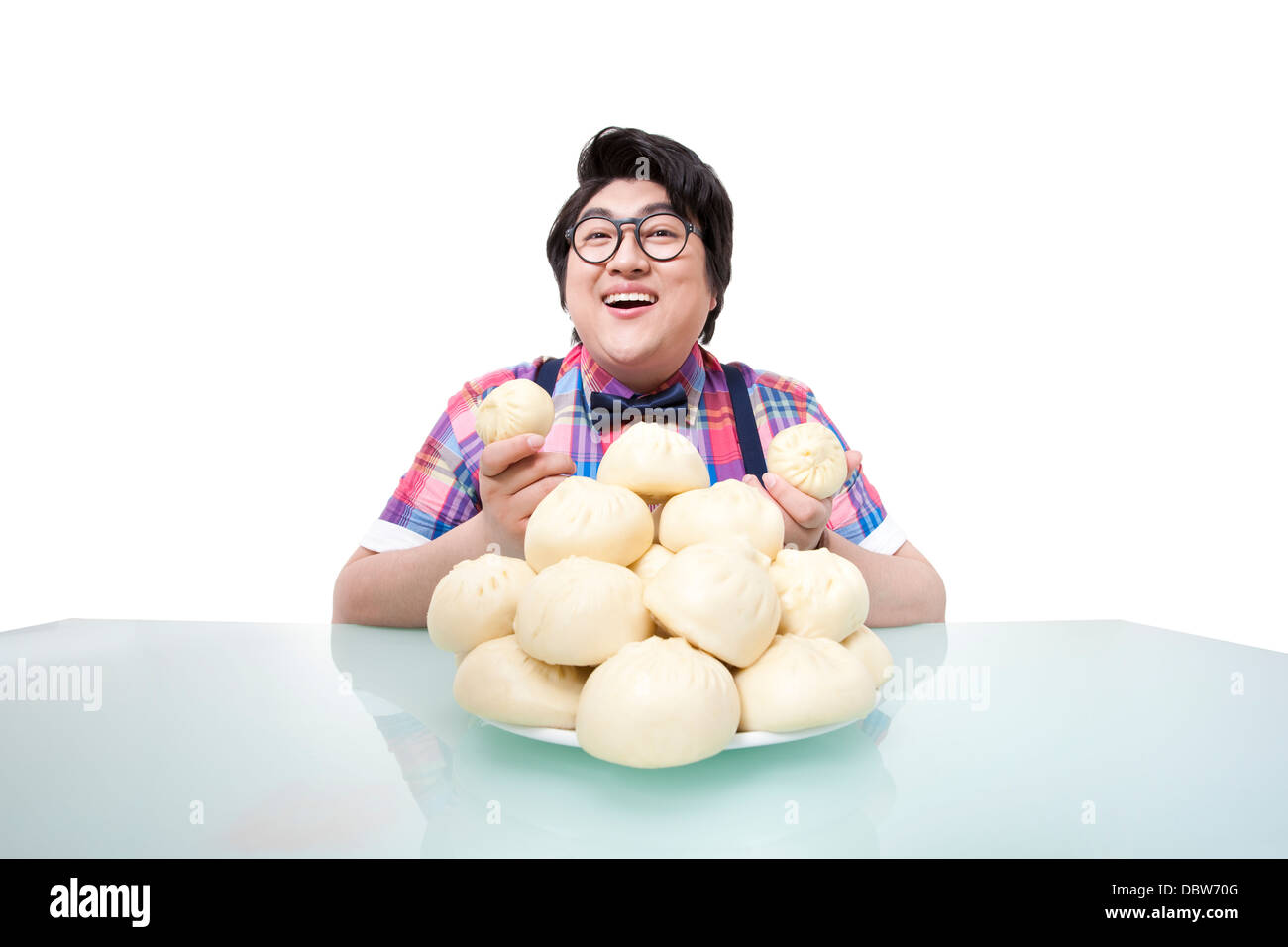 Overweight young man eating steamed stuffed buns Stock Photo - Alamy