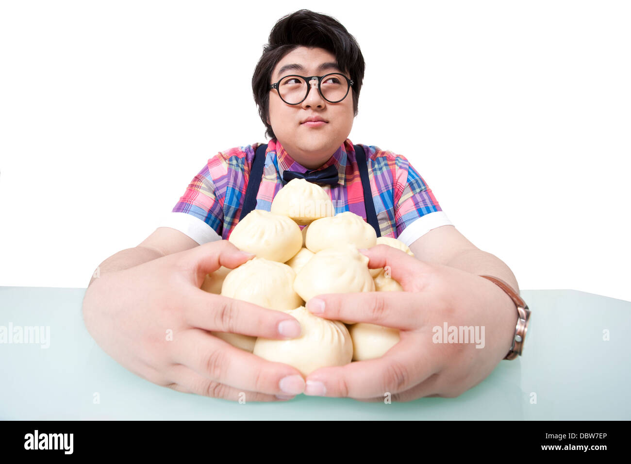 Overweight young man with steamed stuffed buns Stock Photo - Alamy