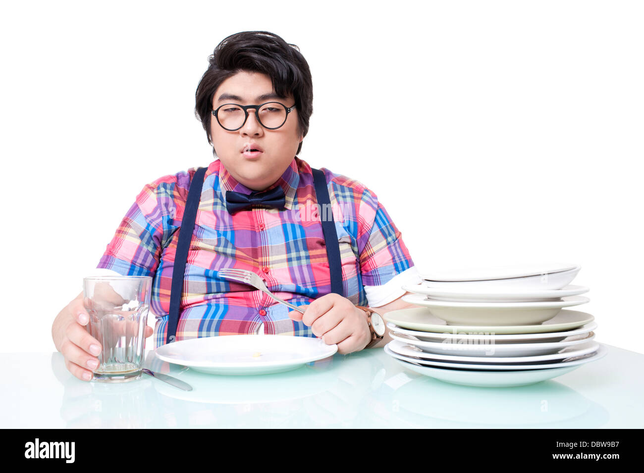 Overweight young man after a big meal Stock Photo - Alamy
