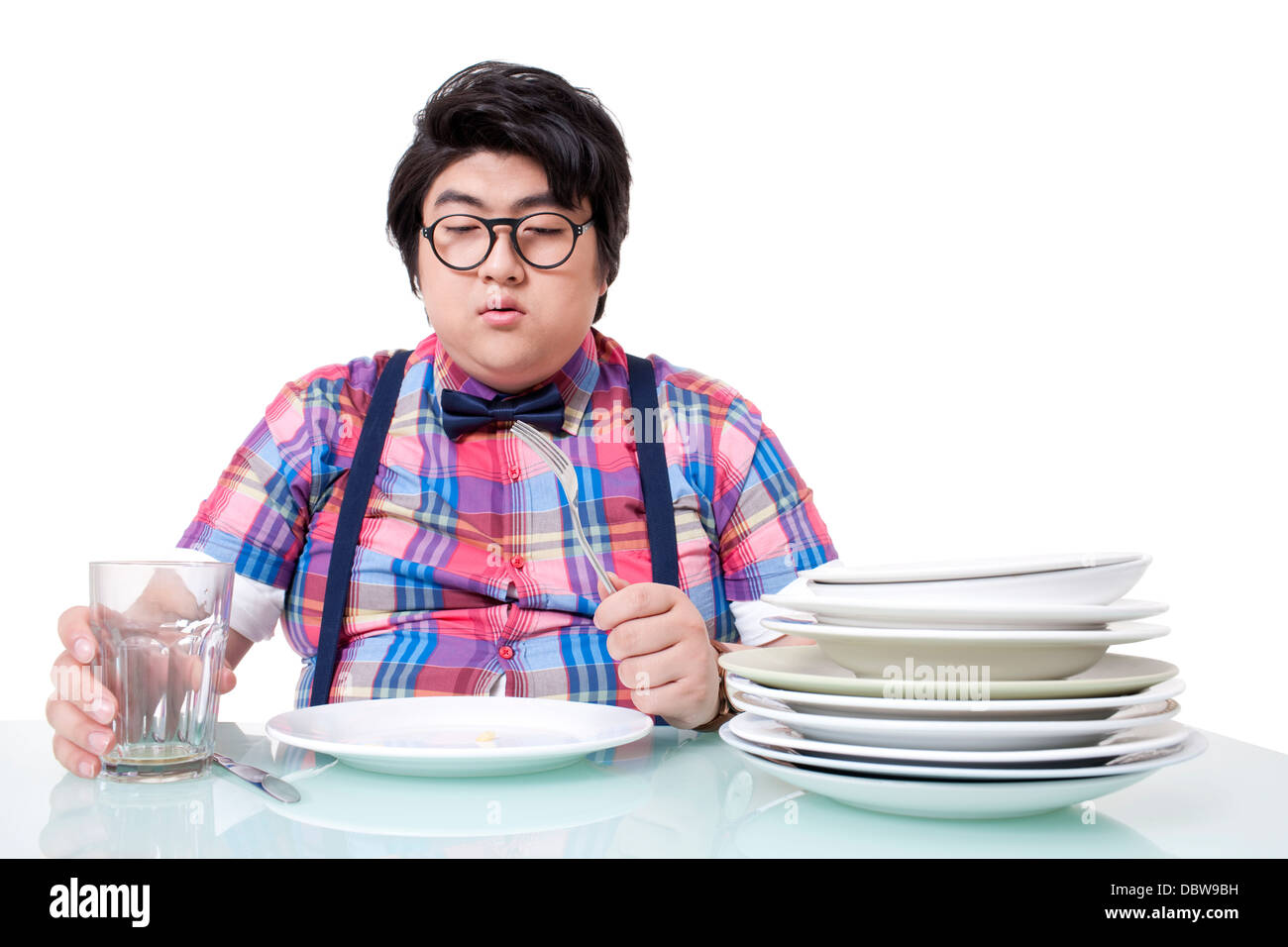 Overweight young man after a big meal Stock Photo - Alamy