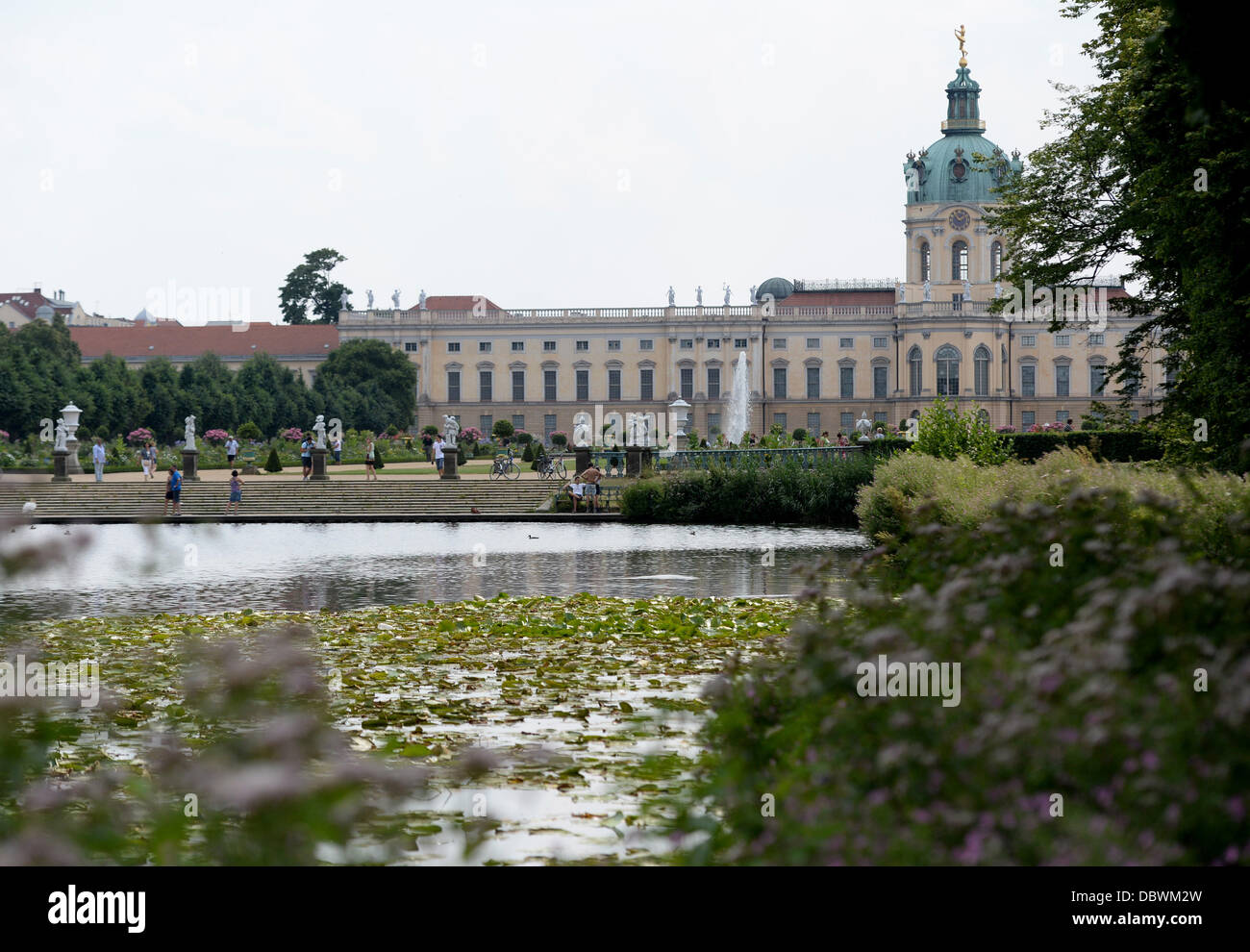 Visitors walk along the outer area of the Charlottenburg Palace in ...