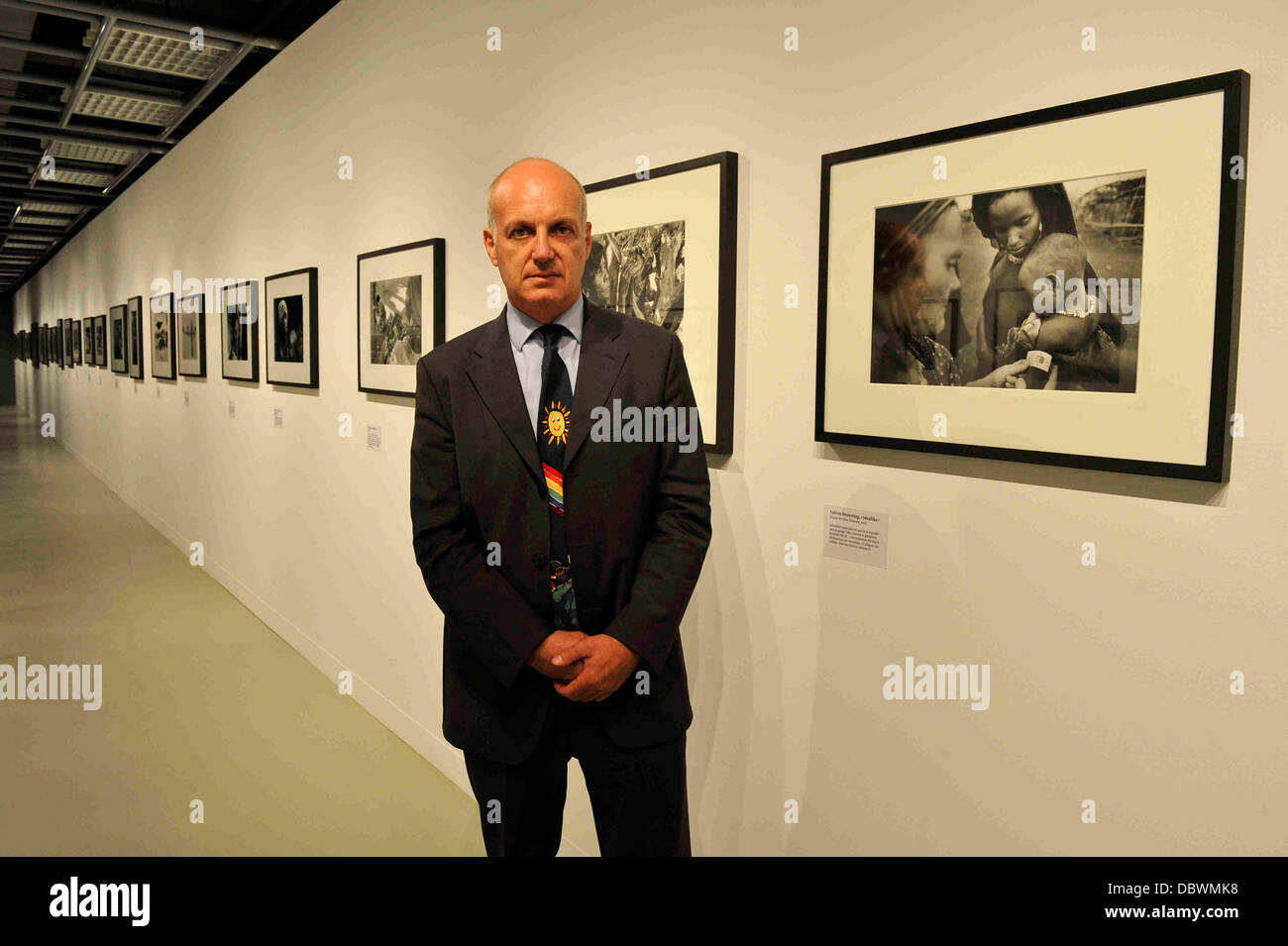 Nick Danziger poses in front of his photographs at his exhibition at ...