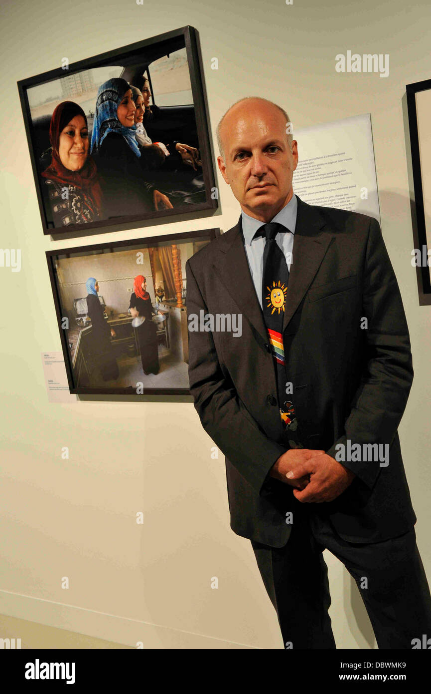 Nick Danziger poses in front of his photographs at his exhibition at ...
