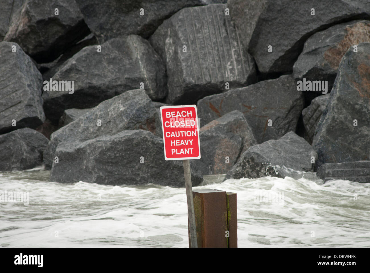 beach closed while rocks are placed to stop coastal erosion Stock Photo ...