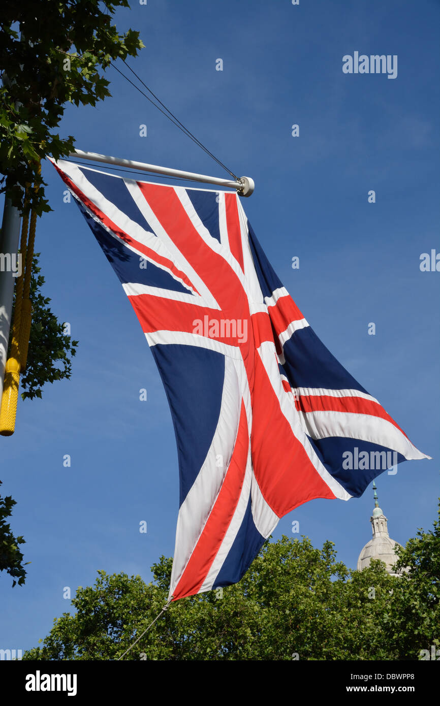 Union Jack flag flying in the wind on a sunny afternoon along Pall Mall ...