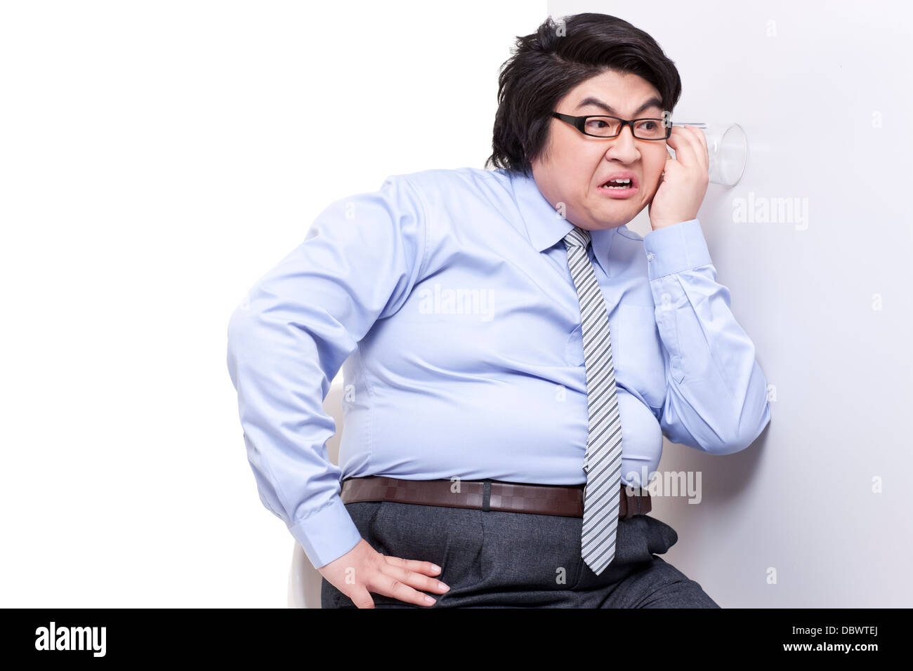 Overweight businessman doing eavesdropping Stock Photo - Alamy