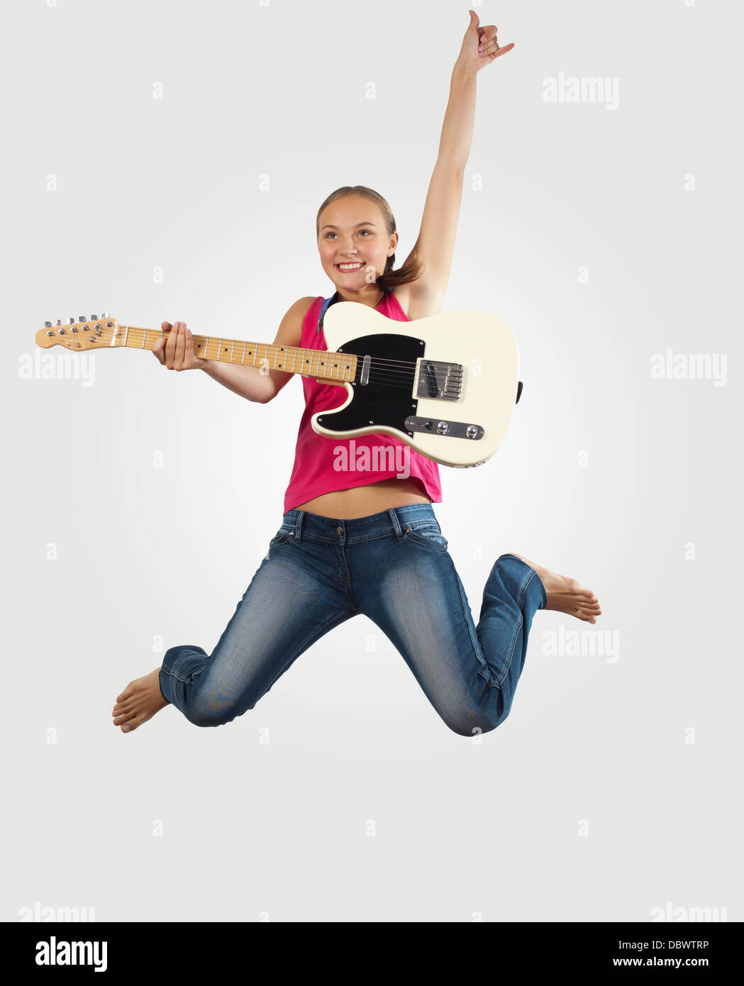 young woman playing on electro guitar and jumping Stock Photo - Alamy