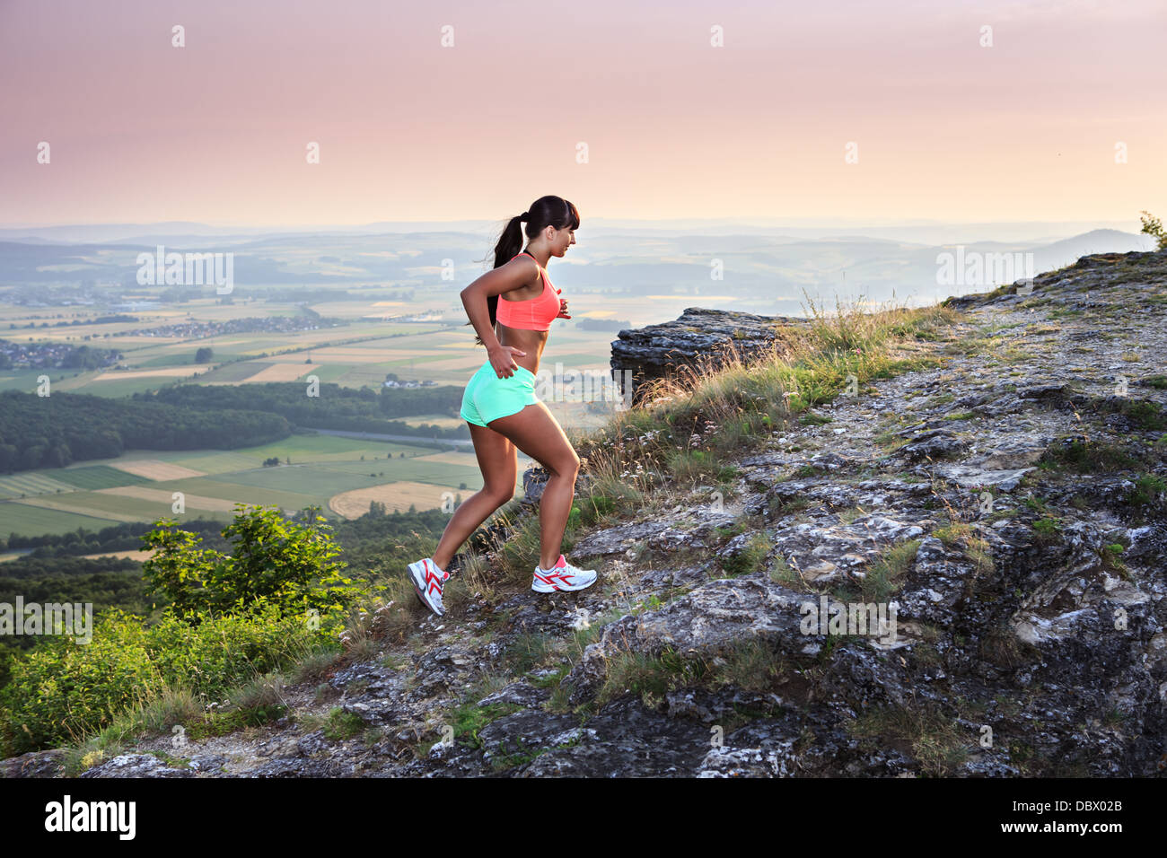 a young woman running in the mountains Stock Photo - Alamy