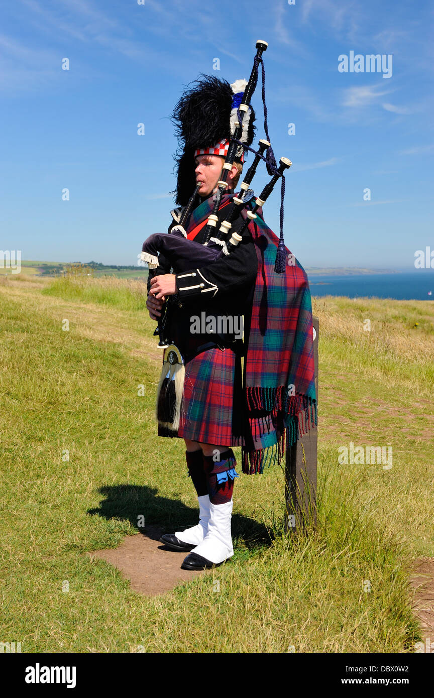 Piper in full highland dress at Dunnottar Castle near Stonehaven ...