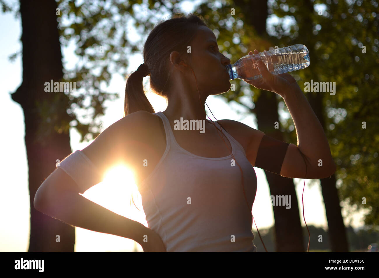young woman drinking water during her workout Stock Photo - Alamy