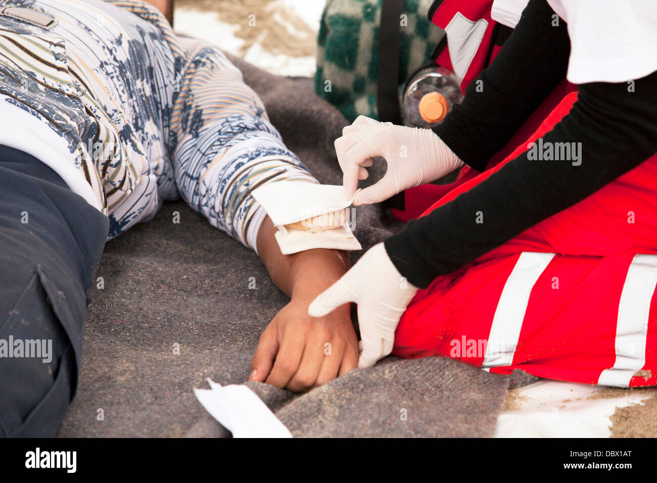 paramedic applying bandage to arm of an accident victim Stock Photo - Alamy