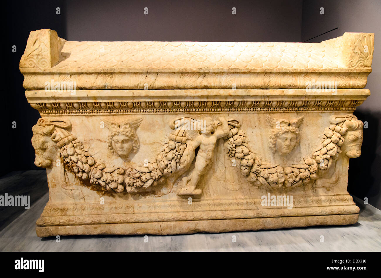 Marble sarcophagus with lid formed as a steeply pitched gable roof ...